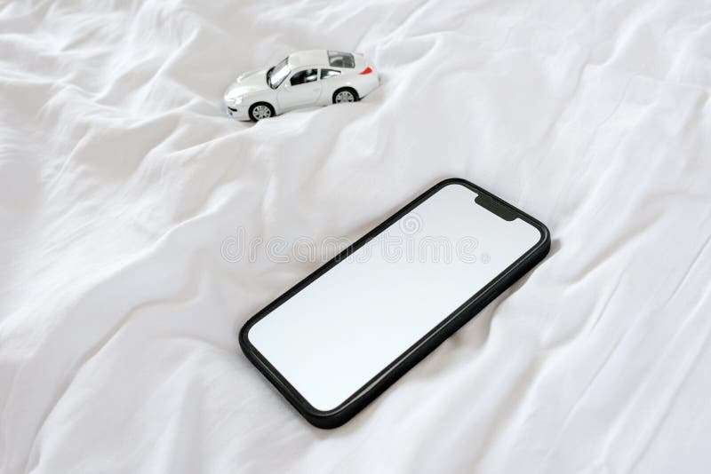 Smartphone and Die Cast Model Car on Bed. Mobile Phone Device with ...