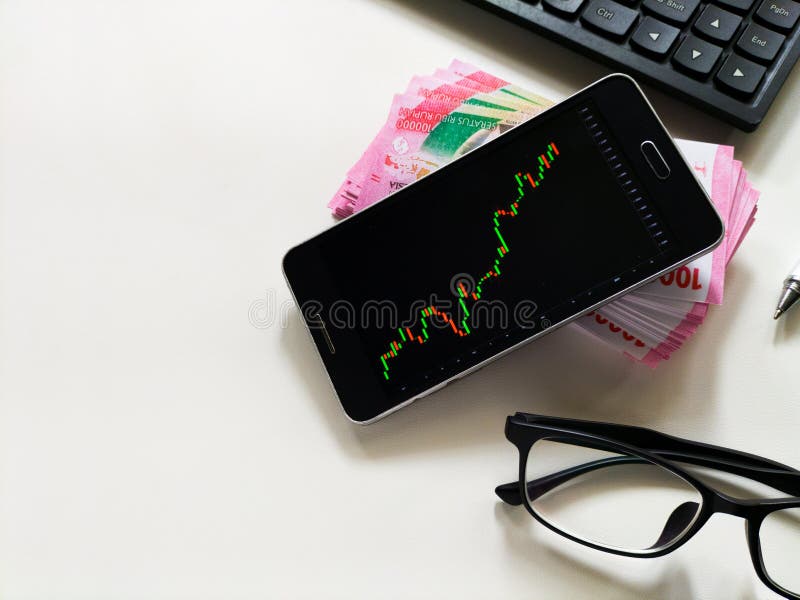 Smartphone Displaying a Chart with a Stack of Indonesian Rupiah ...