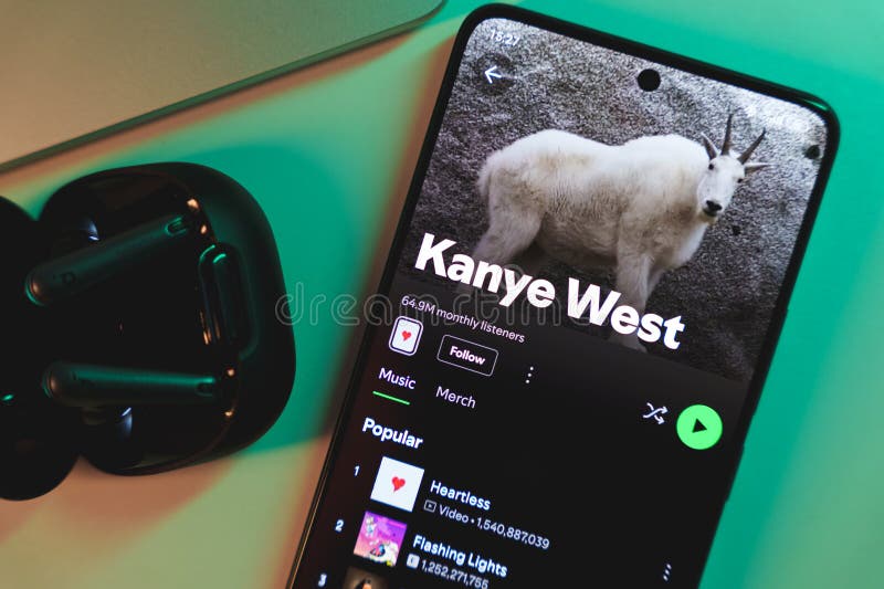 A Smartphone Displaying Kanye West Artist Profile on Spotify Editorial ...