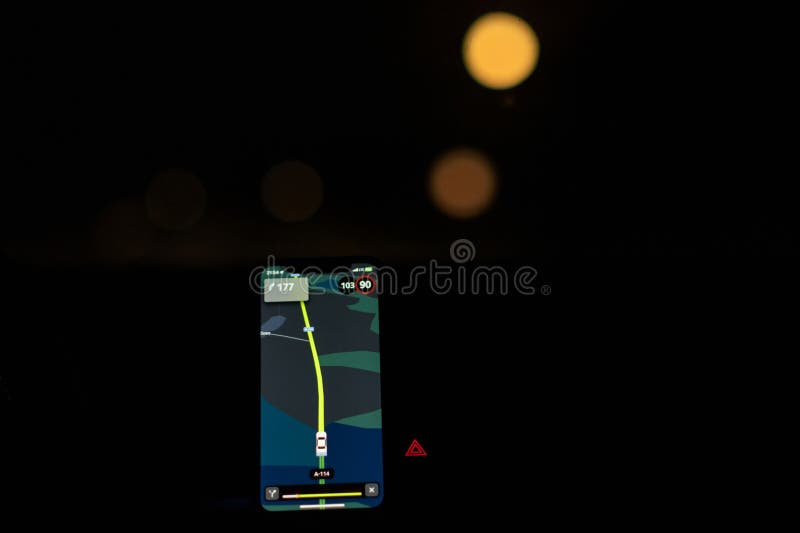 A Smartphone Displays a Navigation App with a Detailed Map while City ...