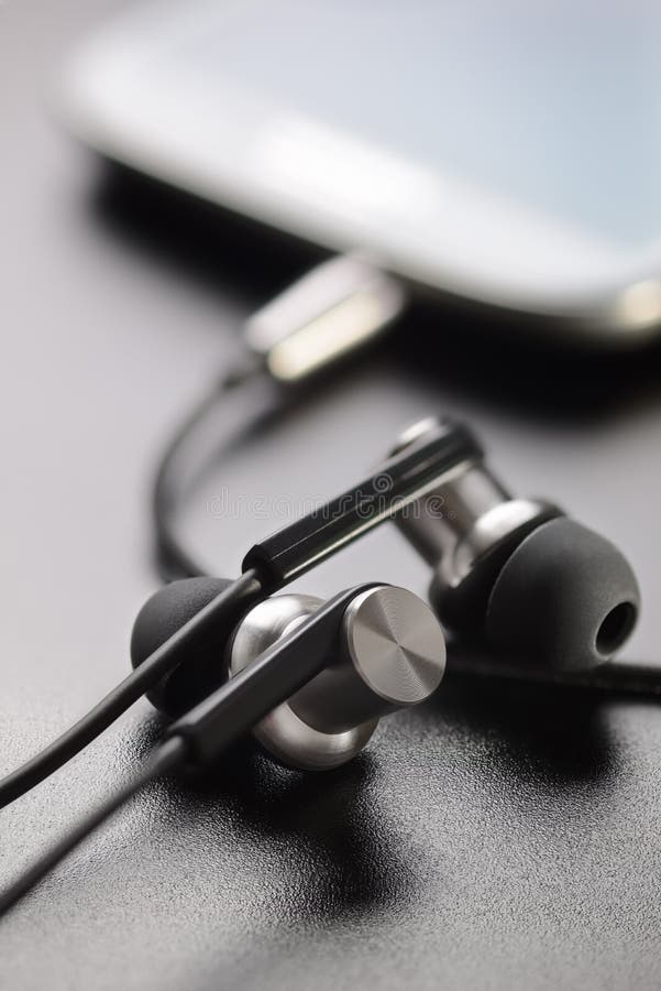 Smartphone and Earphones on Table Stock Image - Image of device ...