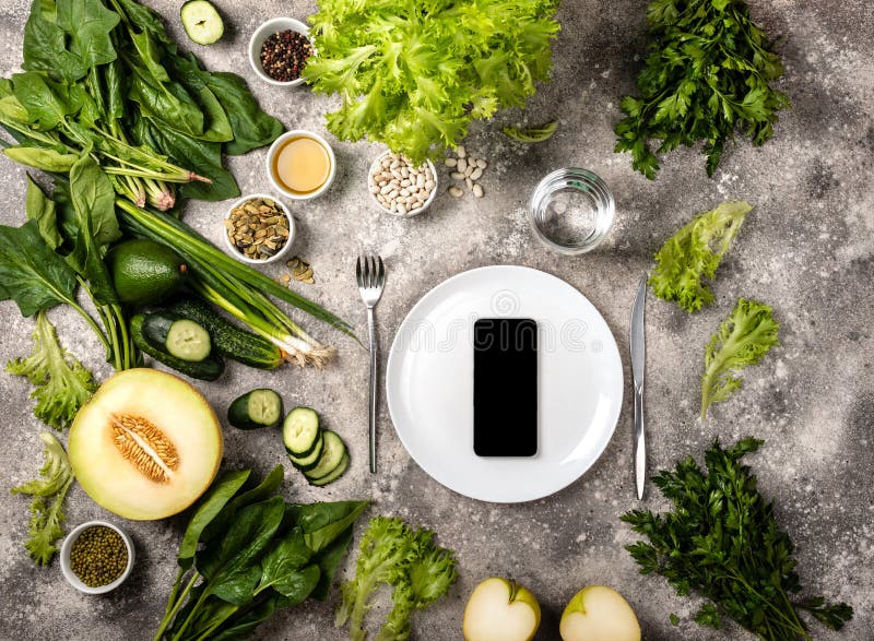 Smartphone on Empty Plate Different Vegetables and Herbs. Stock Image ...