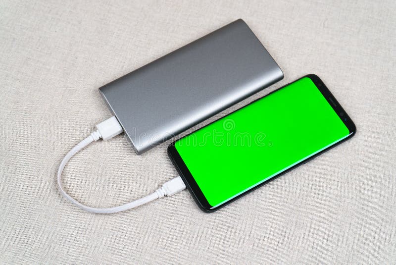 Smartphone with Green Screen Charging with Silver Power Bank Stock ...