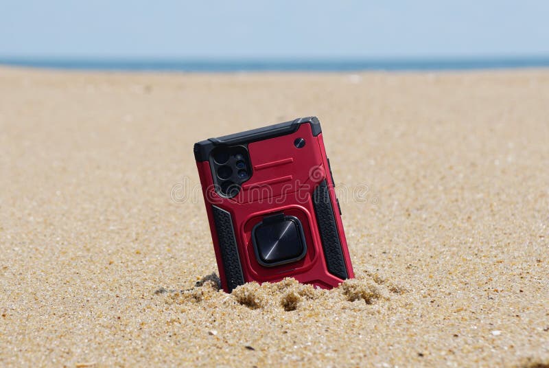 A Smartphone Half-buried in the Sand on the Beach Stock Photo - Image ...