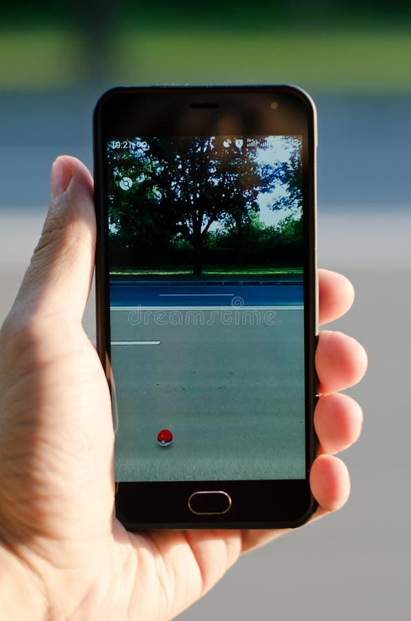 Smartphone in Hand Guy Catches a Pokemon on the Road Editorial Photo ...