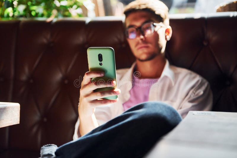 Smartphone in Hand. Man in Casual Clothes Sitting in the Pub Stock ...