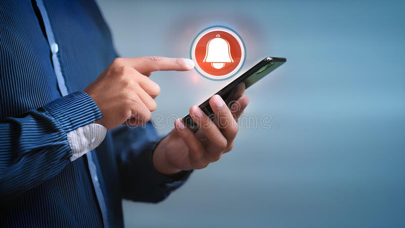 A Smartphone in Hand with a Notification Bell Button on the App Screen ...
