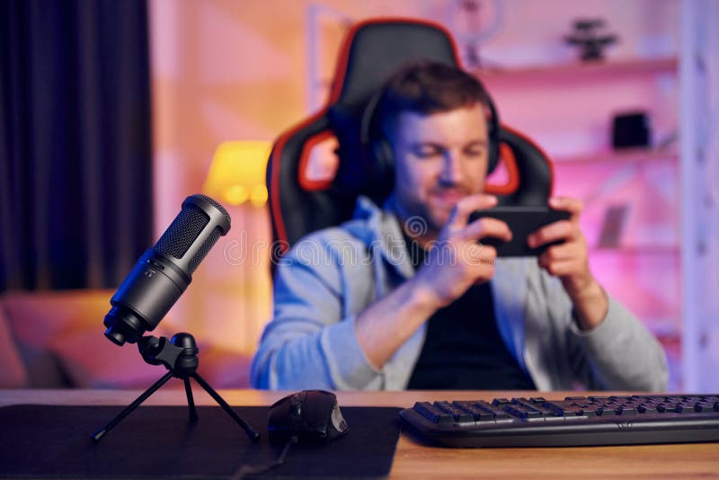 With Smartphone in Hands. Man in Headphones and with Microphone is Live ...