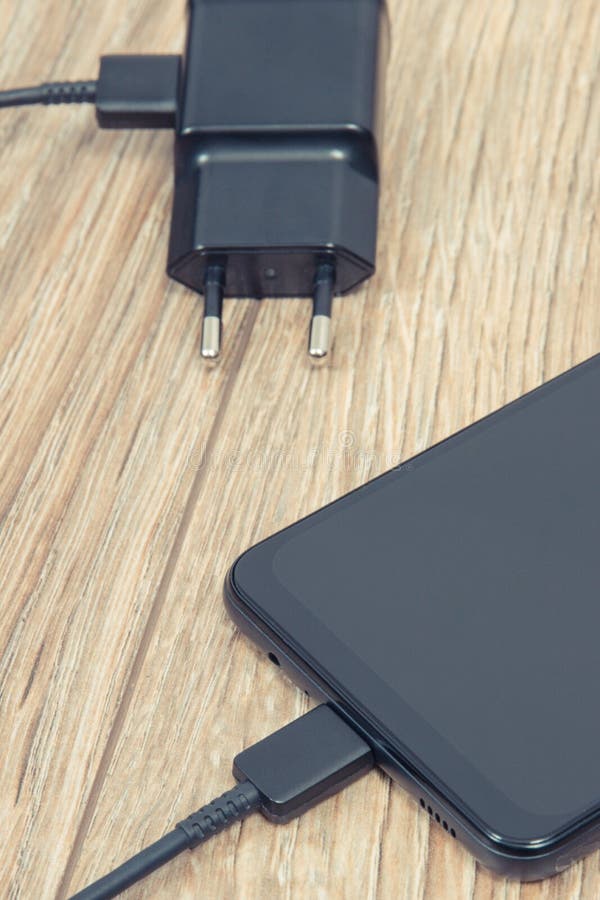 Smartphone and Charger Using To Charge Empty Battery. Various Devices ...
