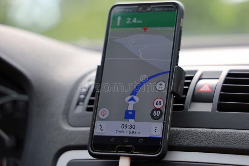 Smartphone with Navigator Map on Dashboard in a Car, Close Up of Navigation with an Gps App ...