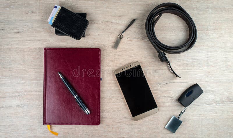 Smartphone, a Notepad, a Ballpoint Pen, a Leather Belt, and Other Men`s ...