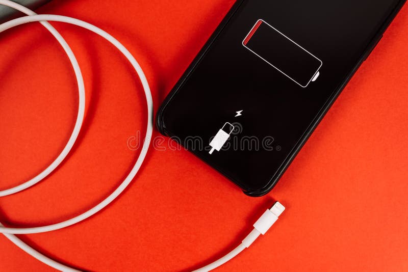 Smartphone on a Red Background with a Low Battery Icon on the Screen ...