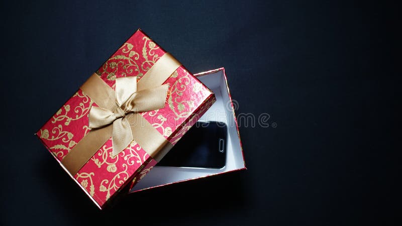 Smartphone in Red Gift Box on Black Background. Stock Photo - Image of ...