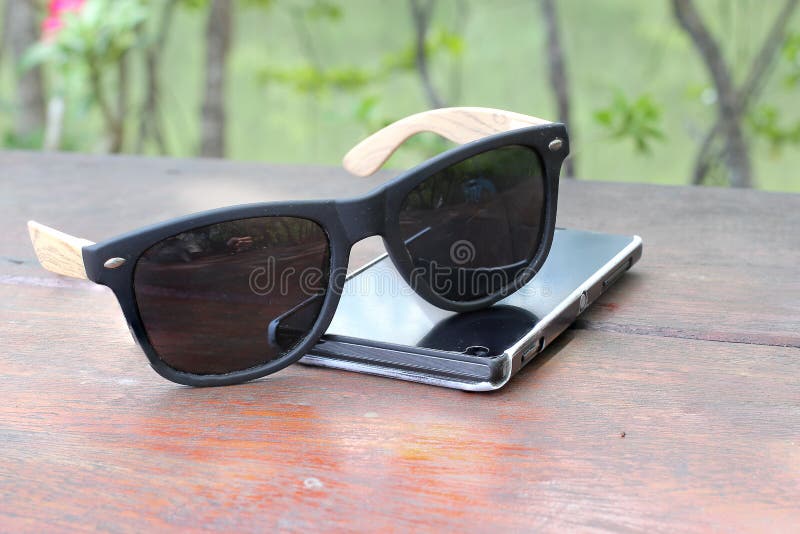 Smartphone and Sunglasses on Wood Table. Stock Photo - Image of ...