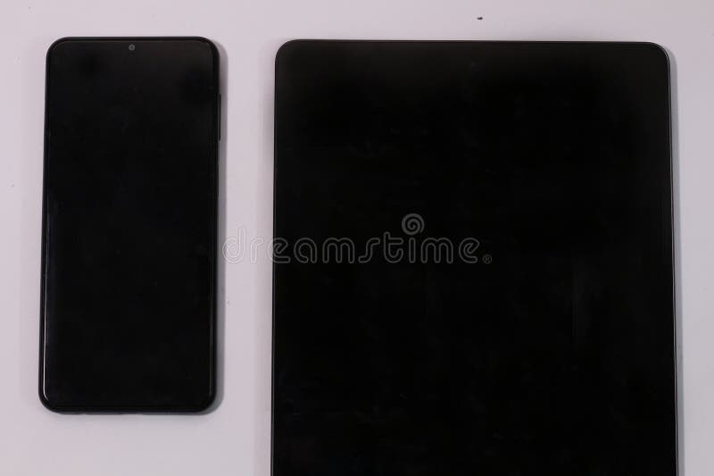 Smartphone and Tablet Side-by-Side on a White Surface Stock ...