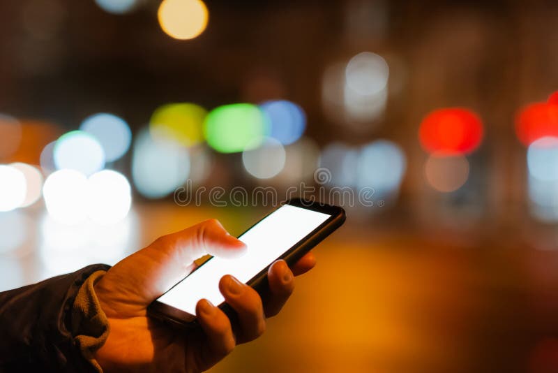 Smartphone with White Screen in Human Hand, Copy Space in Darkness with ...