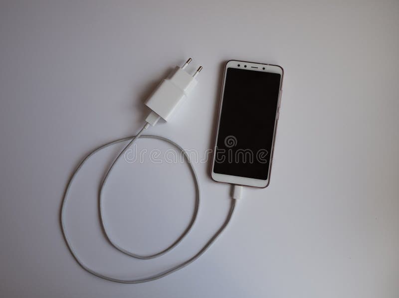 A Smartphone with a White USB Cable for Charging Top View Stock Image ...