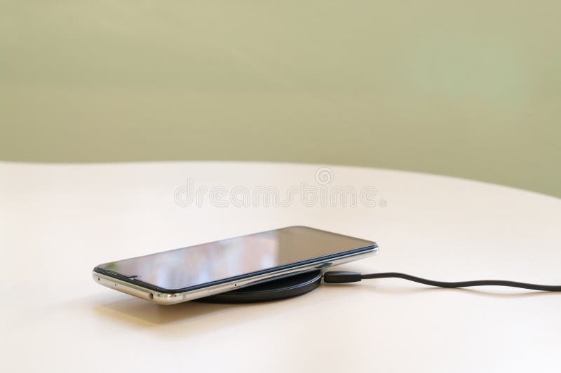 Smartphone Wireless Charging on Induction Charger. Wireless Charger ...