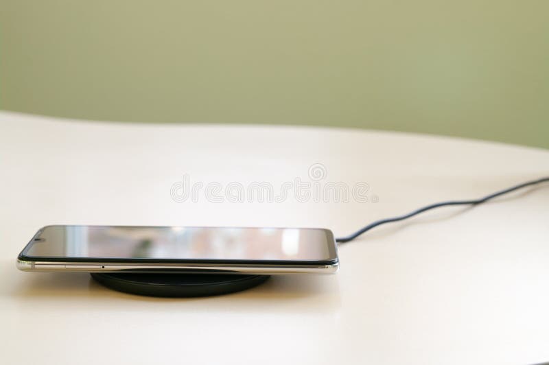 Smartphone Wireless Charging on Induction Charger. Wireless Charger ...
