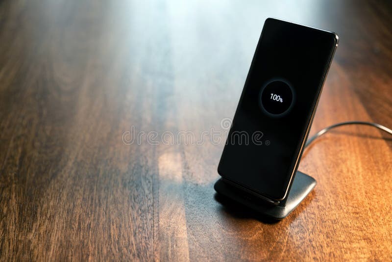 Smartphone Wireless Charging on Charging Stand with 100 Percent Icon on ...