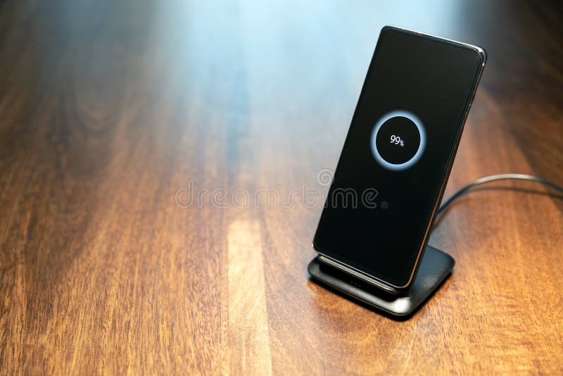 Smartphone Wireless Charging on Charging Stand with 99 Percent Icon on ...