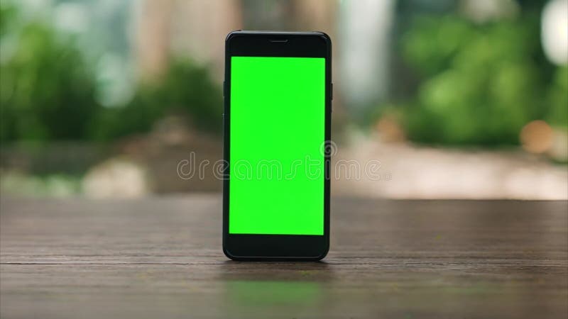 Smartphone on a Wooden Table with Green Screen Display Stock Footage ...