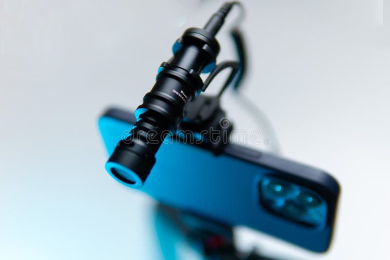 Smartphones Connected To an External Microphone and Coupled To a Tripod ...