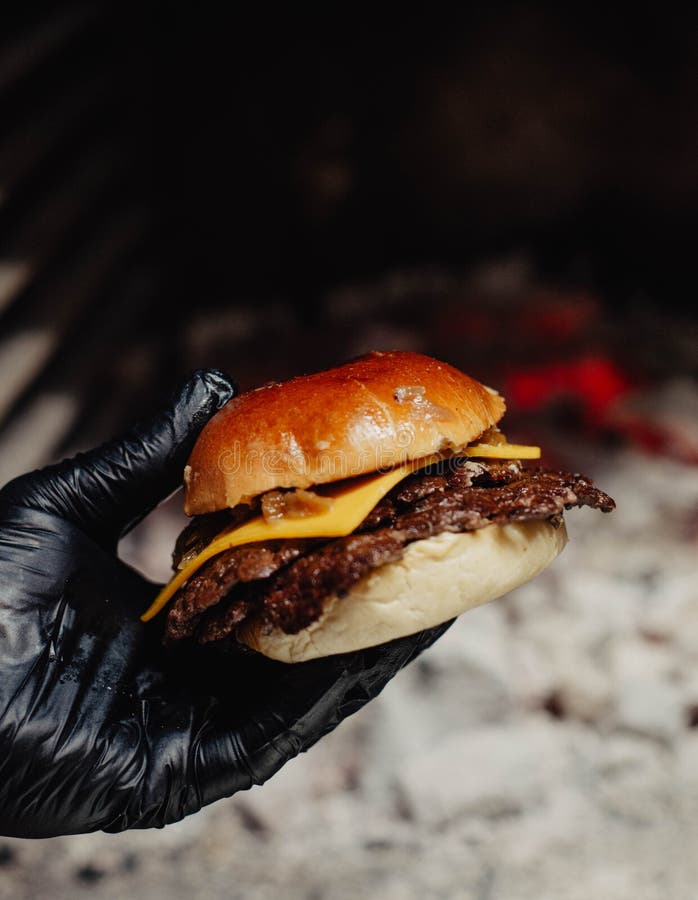 Smashed Cheeseburger on a Wooden Table in Front of a Fireplace. Stock ...
