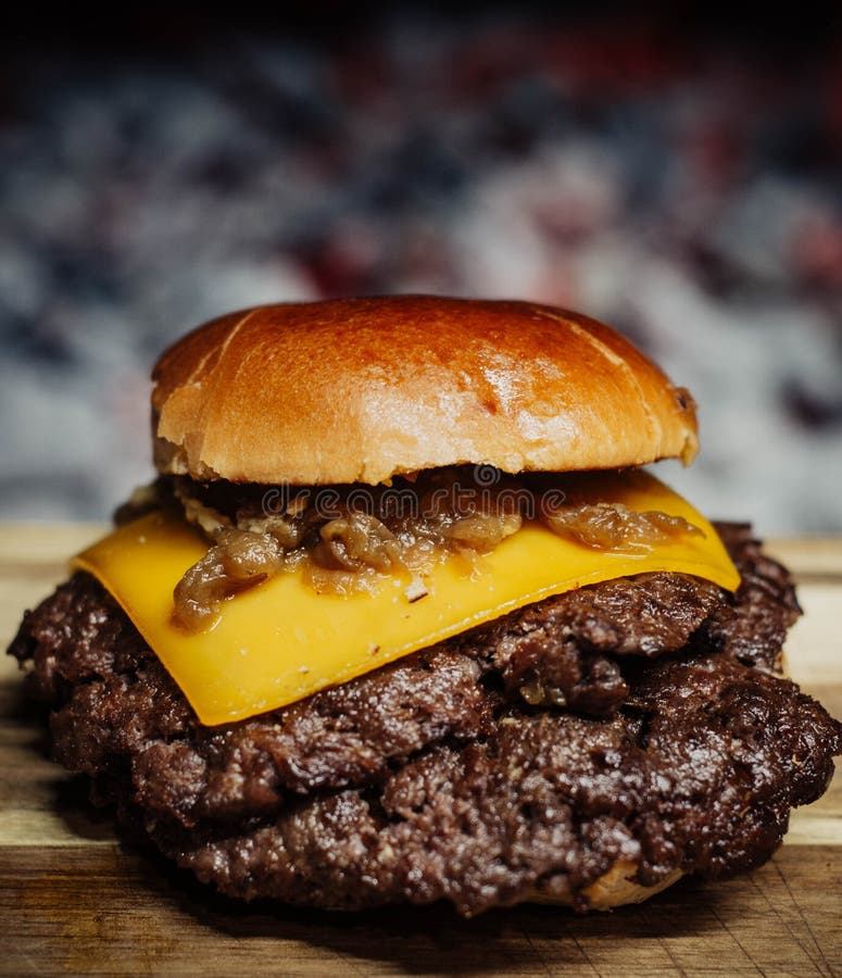 Smashed Cheeseburger on a Wooden Table in Front of a Fireplace. Stock ...