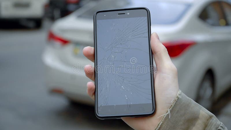 Smashed Glass of Mobile Phone on Table Rotating in Light with Half the ...