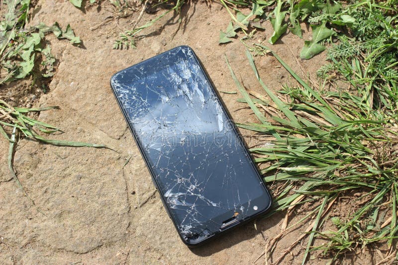 The Smashed Smartphone Lies on the Ground, the Display is Damaged Stock ...