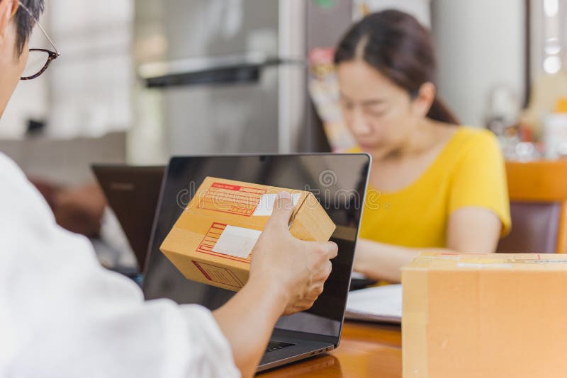 SME Businessman Holding Paecel Box with Open Labtop on Table. Stock ...