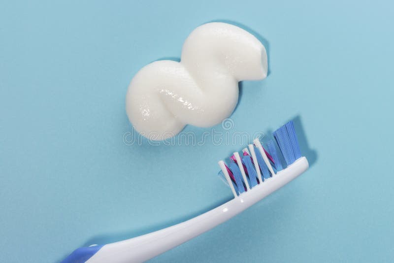 A Smear of Toothpaste and Toothbrush on a Blue Background Top View ...