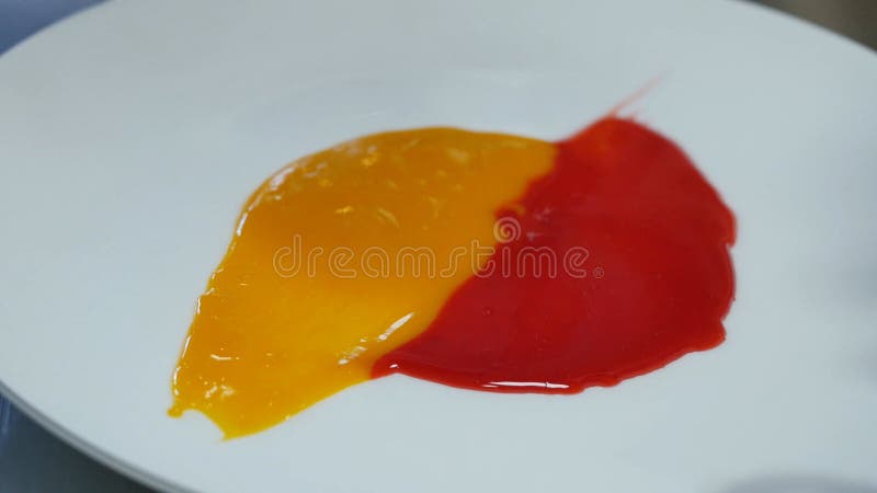 Smearing Jam on a Plate. Two Kinds of Jam Smeared on the Plate with a ...