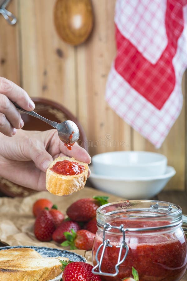Smearing Strawberry Jam on a Toast for Breakfast Stock Photo - Image of ...