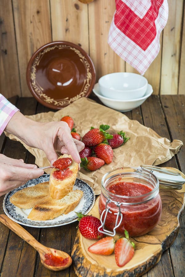 Smearing Strawberry Jam on a Toast for Breakfast Stock Photo - Image of ...