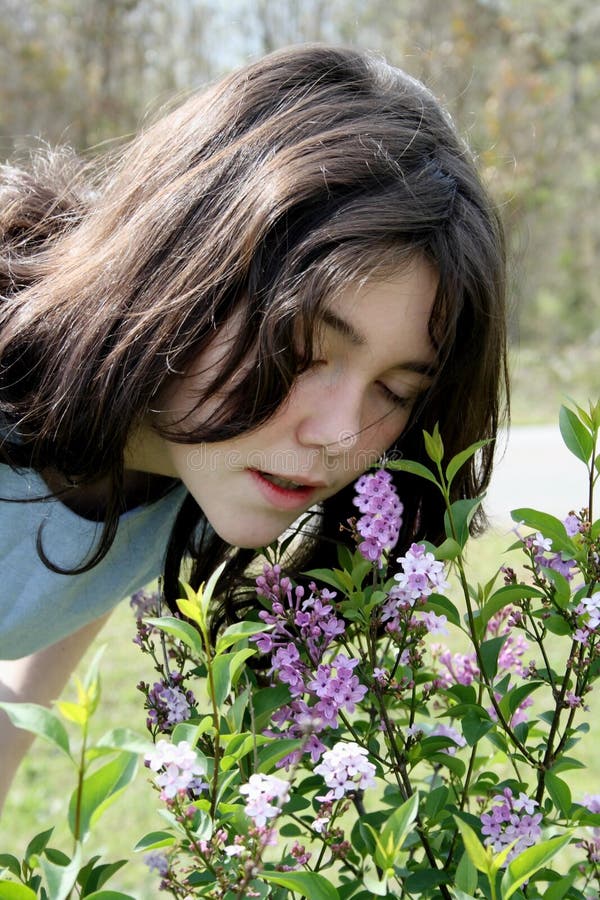 Smell the flowers stock photo. Image of flower, brunette - 6961132