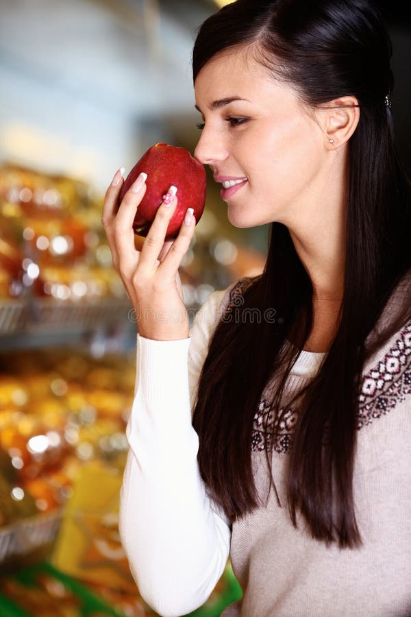 Smelling apple stock photo. Image of holds, consumer - 24739104
