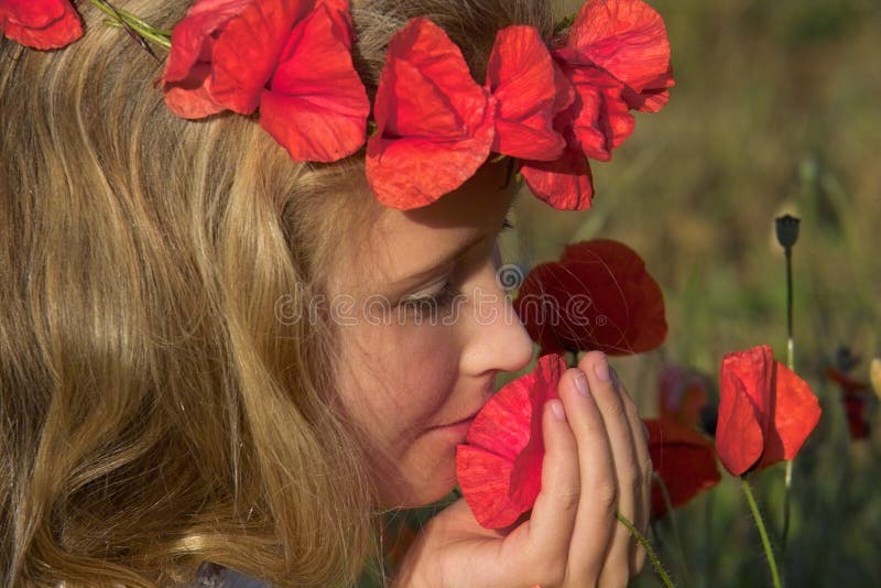 Smelling the poppies stock image. Image of people, human - 200975
