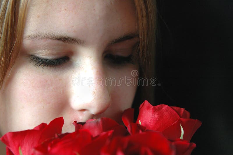 Smelling red roses stock image. Image of profile, roses - 1412041