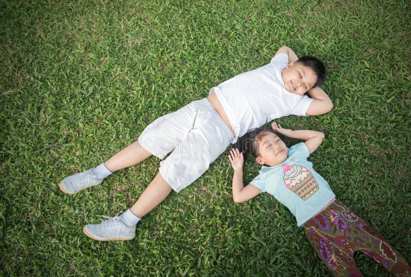 Smile Children Lie Down on Grass Stock Image - Image of lying, portrait ... Smile Children Lie Down on Grass Stock Image - Image of lying, portrait ...