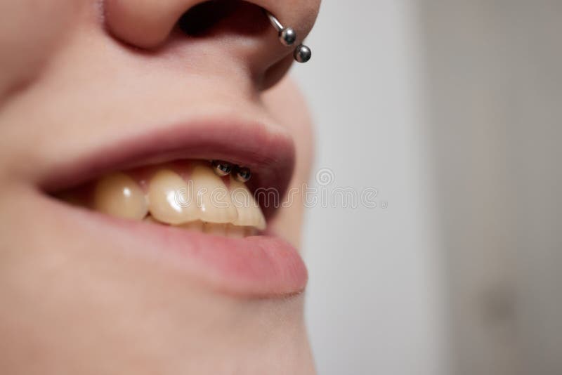 Smile or Frenulum Piercing Under the Upper Lip. Stock Image - Image of ...