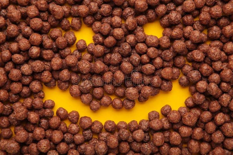Smile Made of Chocolate Corn Balls on Yellow Background Stock Photo ...