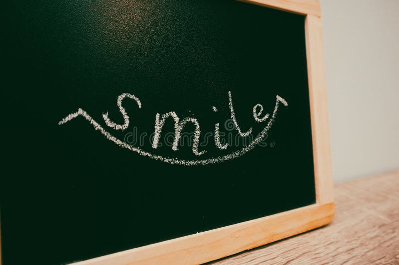 Smile. Text Handwritten in Chalk on a Chalkboard Stock Photo - Image of ...
