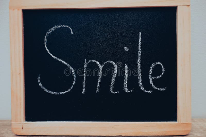 Smile. Text Handwritten in Chalk on a Chalkboard Stock Image - Image of ...