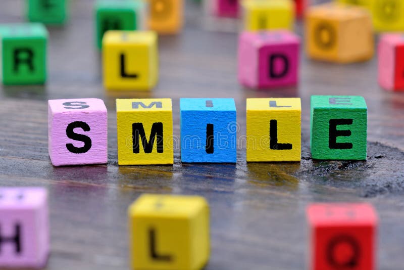 Smile Word Written in Cube on Wooden Floor on White Background Stock ...