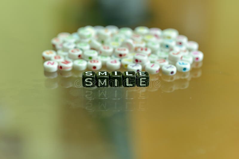 SMILE Written with Acrylic Black Cube with White Alphabet Beads on the ...