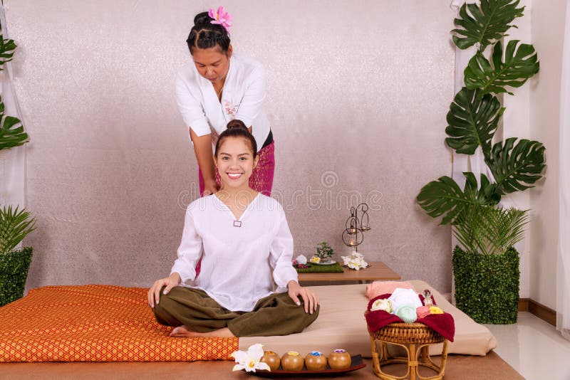 Smile Young Woman Getting Thai Herbal Massage With Hand Of Masseuse On