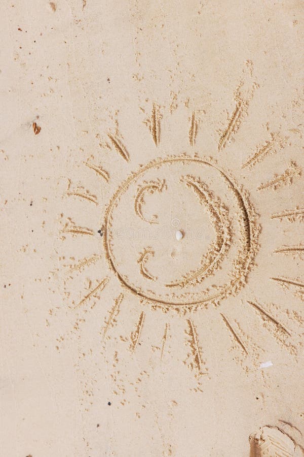 Smiley Face Drawn in Sand on Beach with Sun and Waves in Background ...
