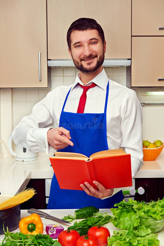 Smiley Young Man Pointing at the Cookbook Stock Photo - Image of happy ...